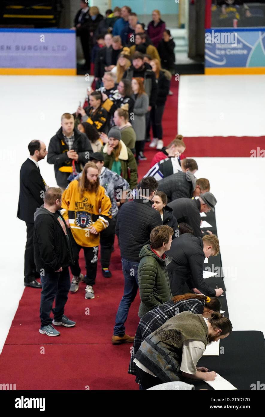People queue to sign a book of condolence as they attend a memorial for ...