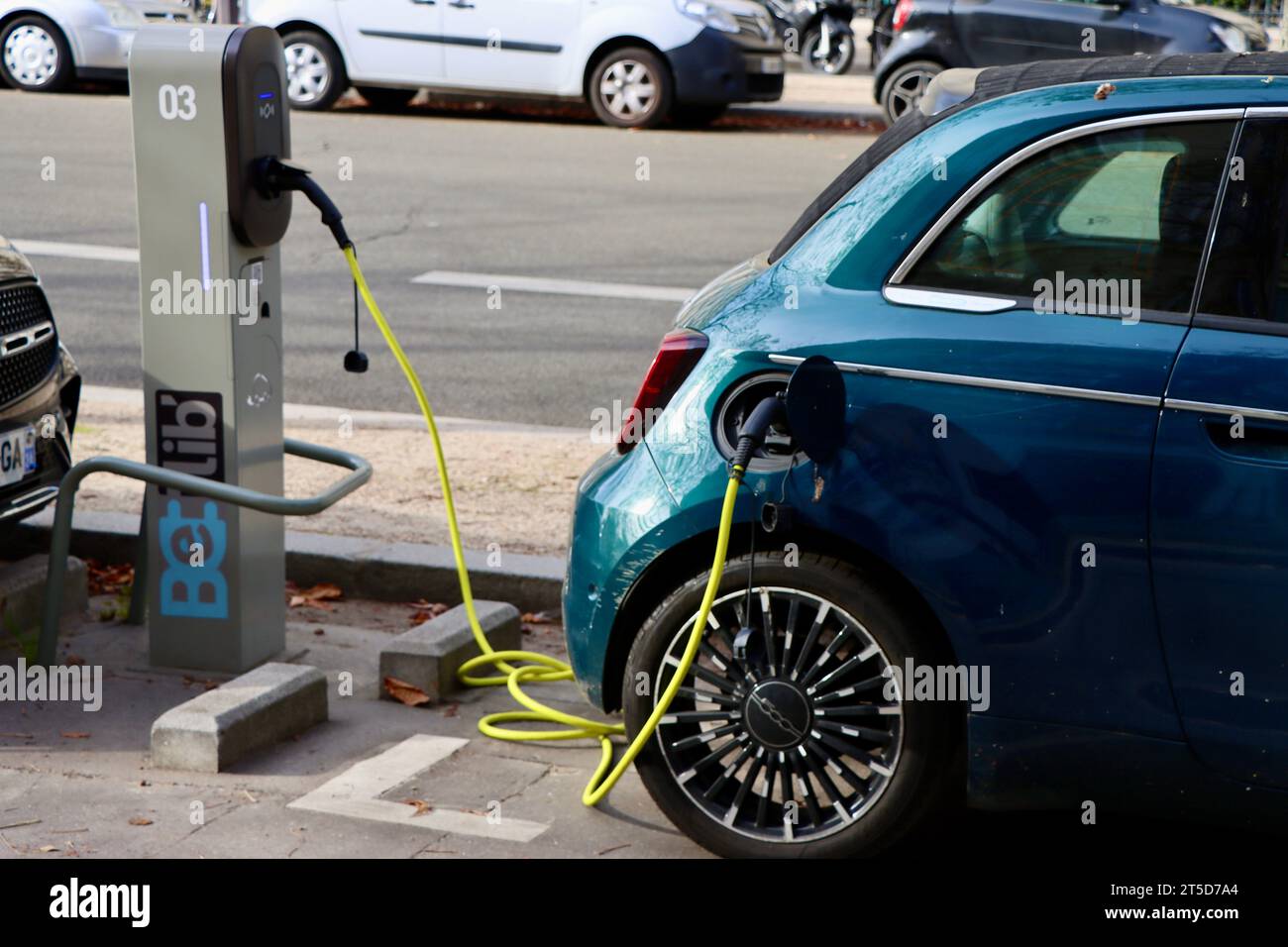 Electric car being charged at charging station in central Paris, France ...