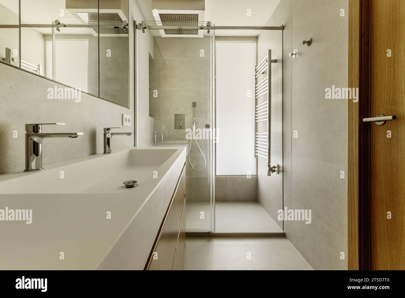Beautiful modern bathroom with gray stone-like tiles, large mirror ...