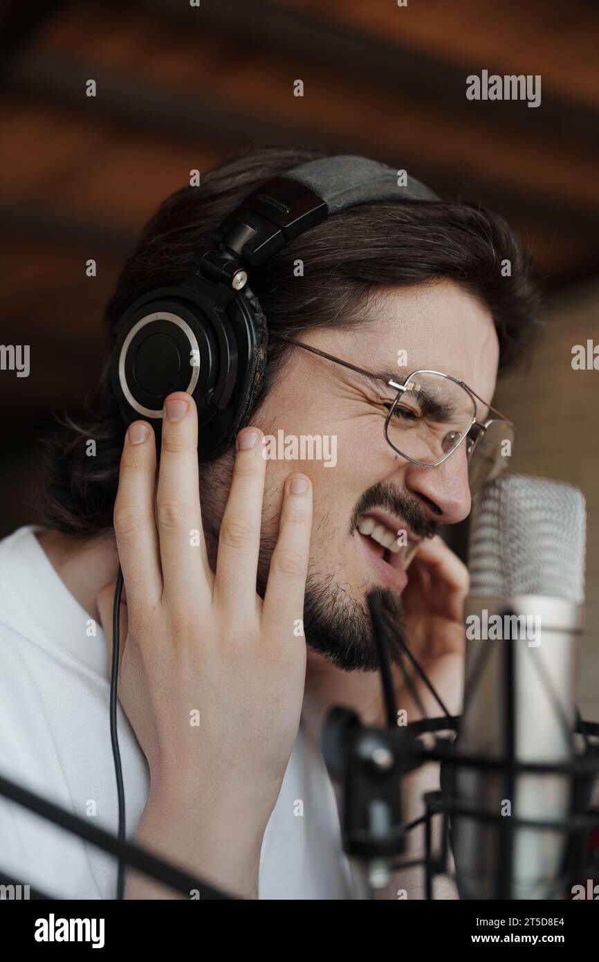 Man singing in recording studio Stock Photo - Alamy