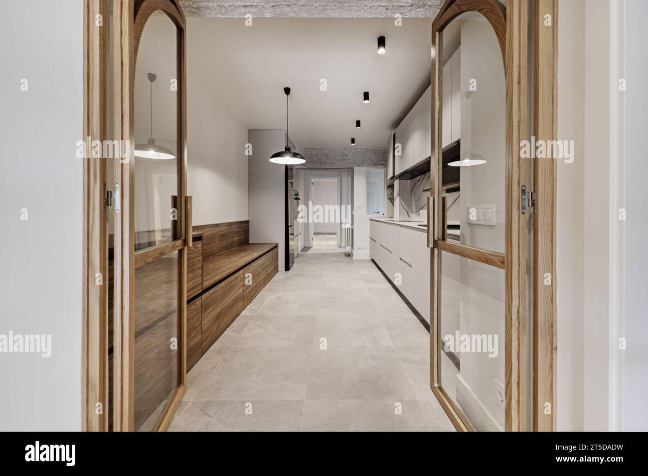 Access to an elongated kitchen with double glass Stock Photo - Alamy