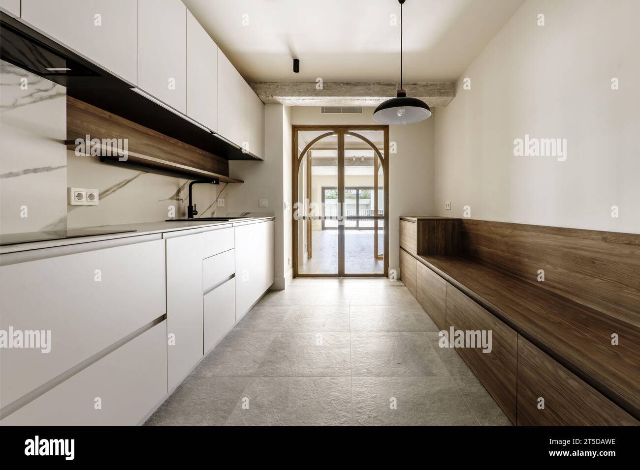 elongated kitchen with double glass and wooden doors with black lamps ...