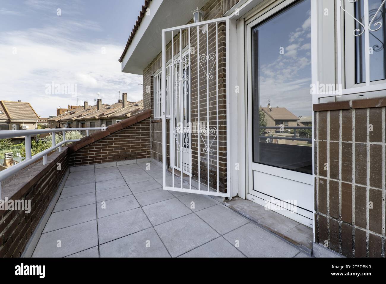 Small terrace with white railing and white stoneware floor, metal ...