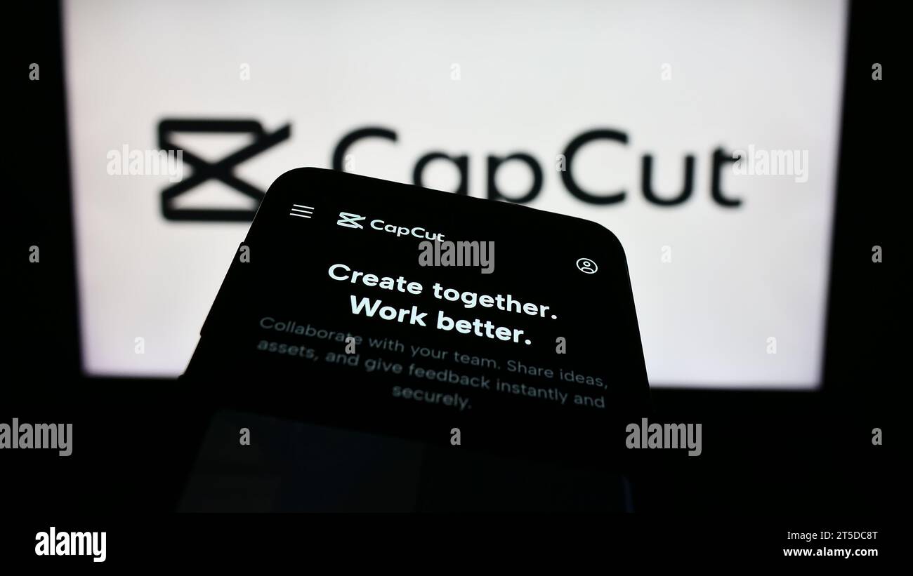 Mobile phone with website of video editing app CapCut in front of ...