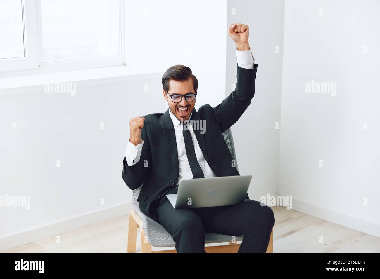 Man happy businessman winner technology laptop job chair business ...