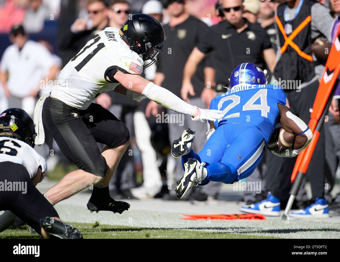 Army linebacker Zane Poulter, left, pushes over Air Force running back ...