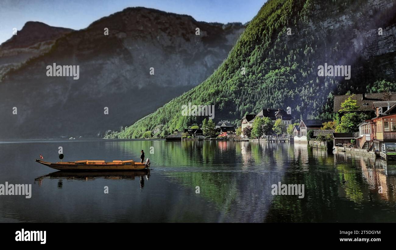 Boat leaving bay Stock Photo - Alamy