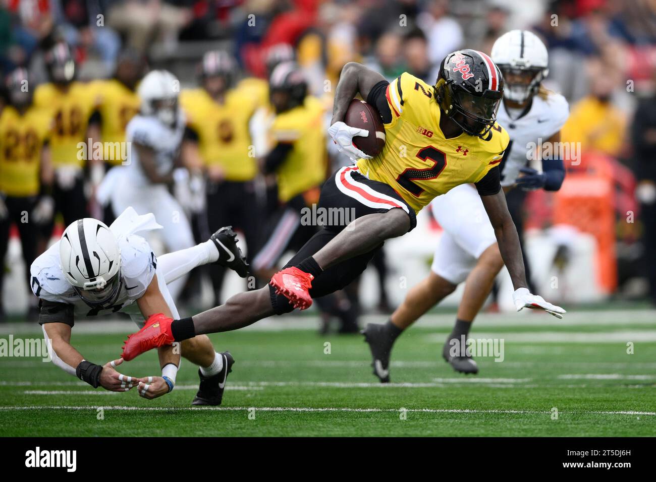 Maryland tight end Corey Dyches (2) is tripped by Penn State linebacker ...