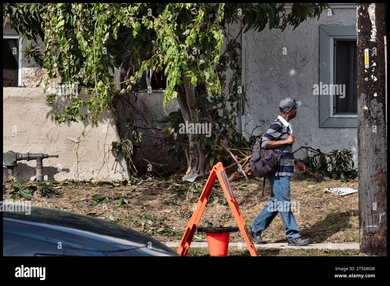 A pedestrian glances over to an apartment where a crash occurred in the ...