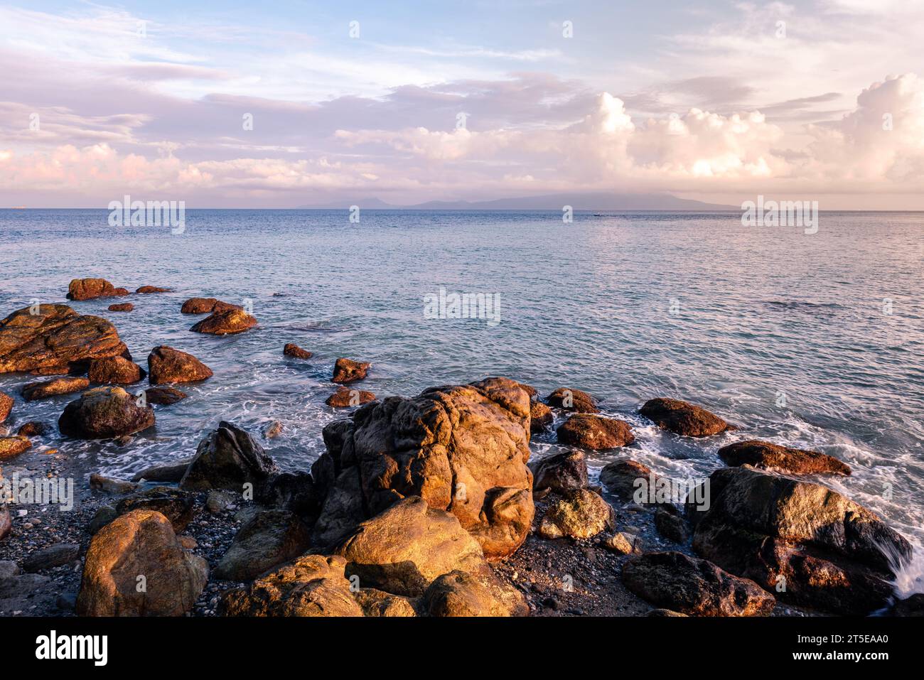 Scenic rock formation during sunrise at the beach of Mindoro ...