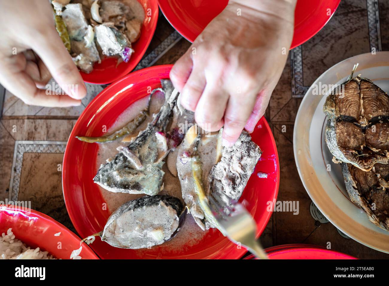Eating at the beach resorts with fish as the main dish Stock Photo - Alamy