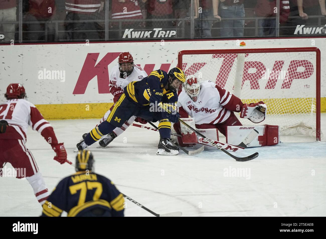 Michigan's Dylan Duke (25) shoots against Wisconsin goalie Kyle ...