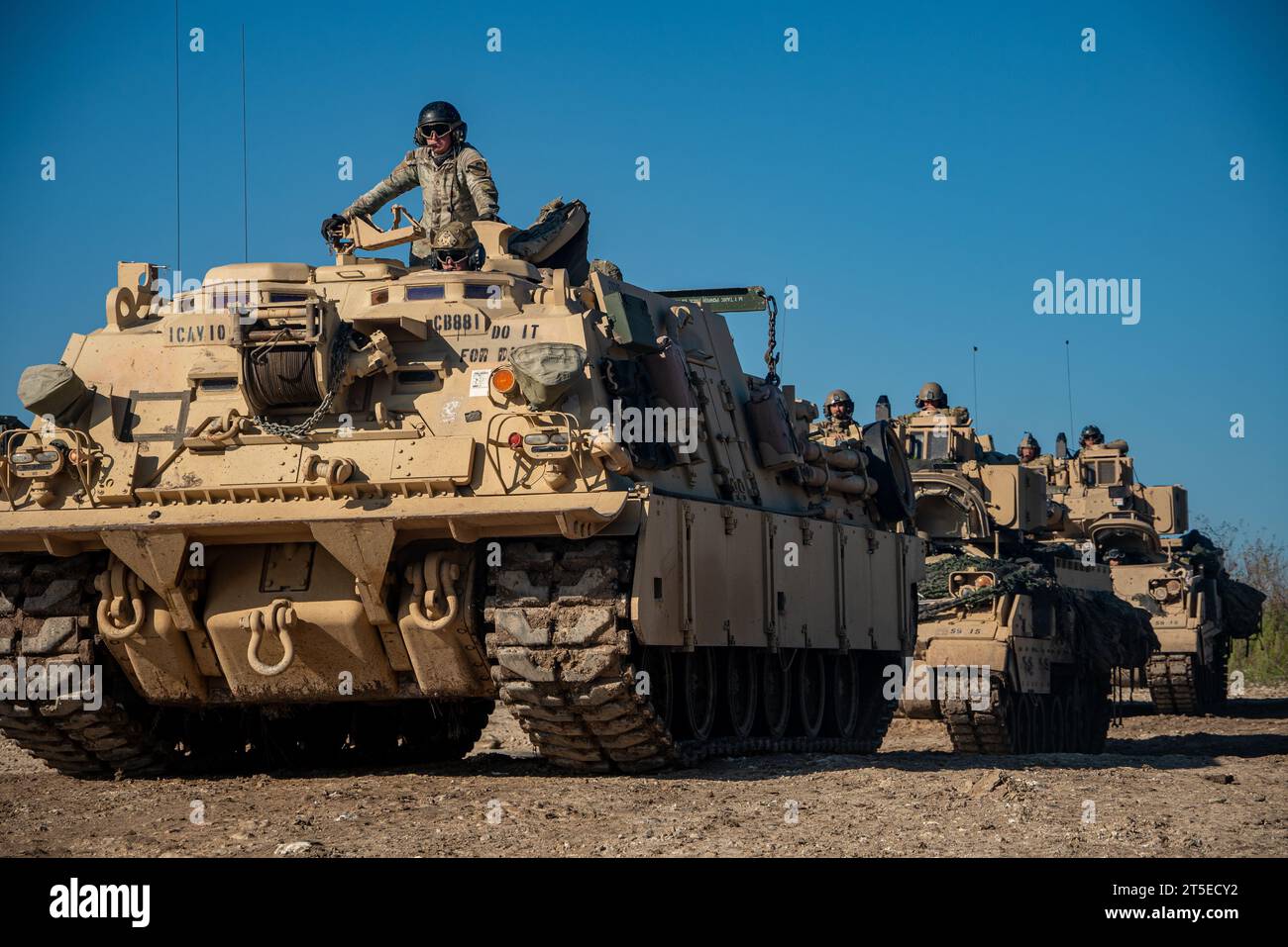 Armored vehicles stand in line waiting to cross Belton Lake during ...