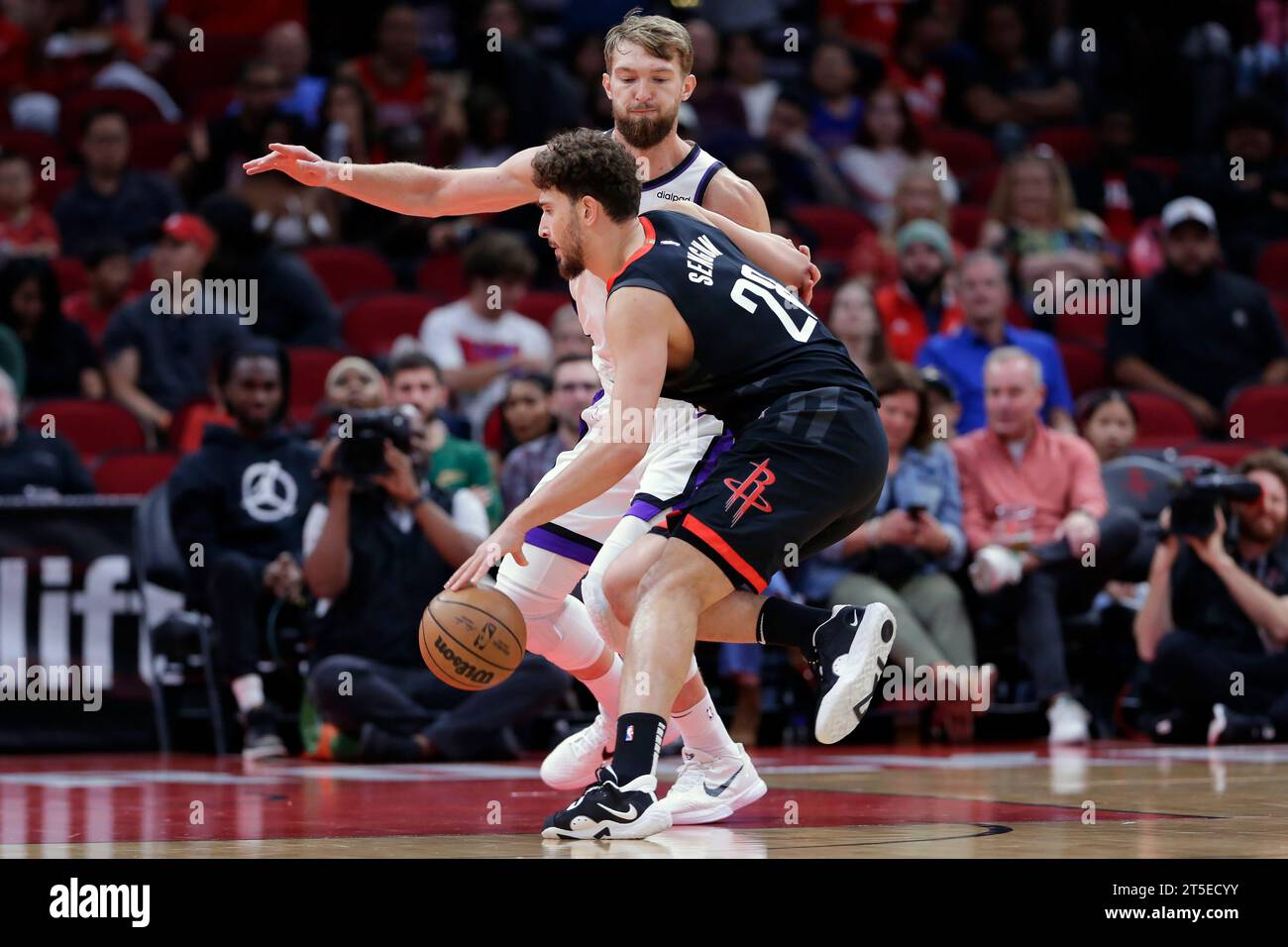 Houston Rockets center Alperen Sengun, front, attempts to drive around Sacramento Kings forward ...