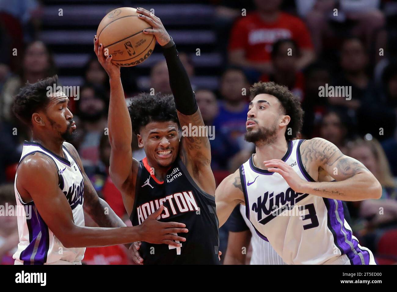 Houston Rockets guard Jalen Green, center, attempts to drive between ...