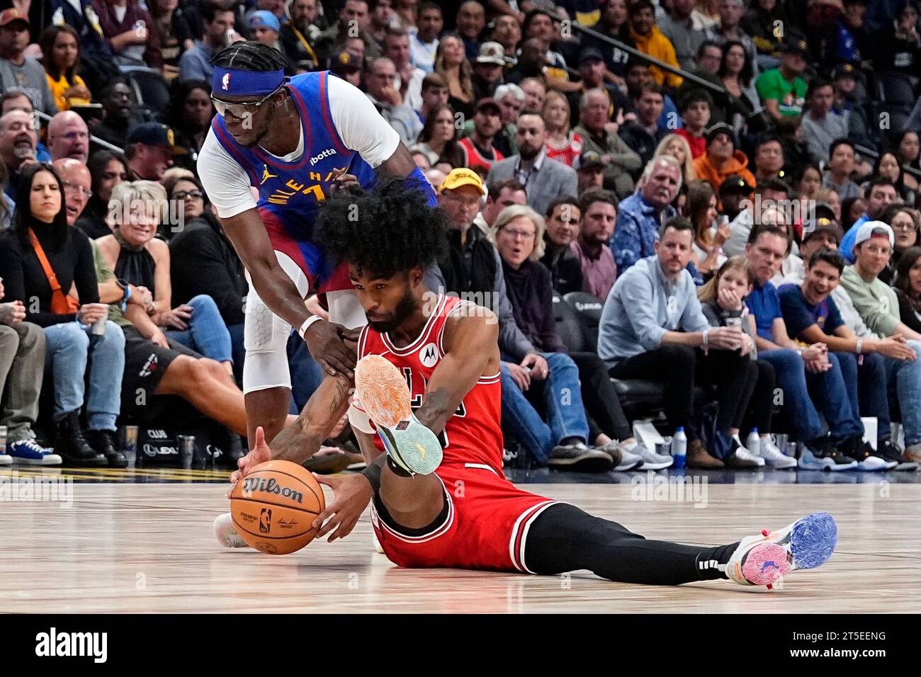 Chicago Bulls guard Coby White (0) grabs a loose ball against Denver ...