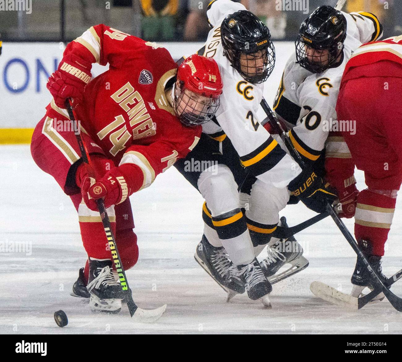 Denver forward Rieger Lorenz (14) battles Colorado College forwards ...