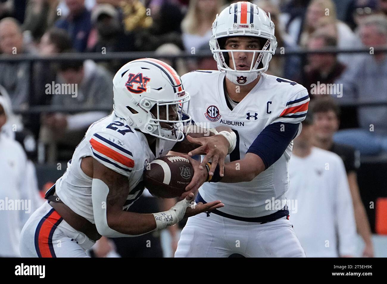Auburn quarterback Payton Thorne, right, hands the ball off to running ...