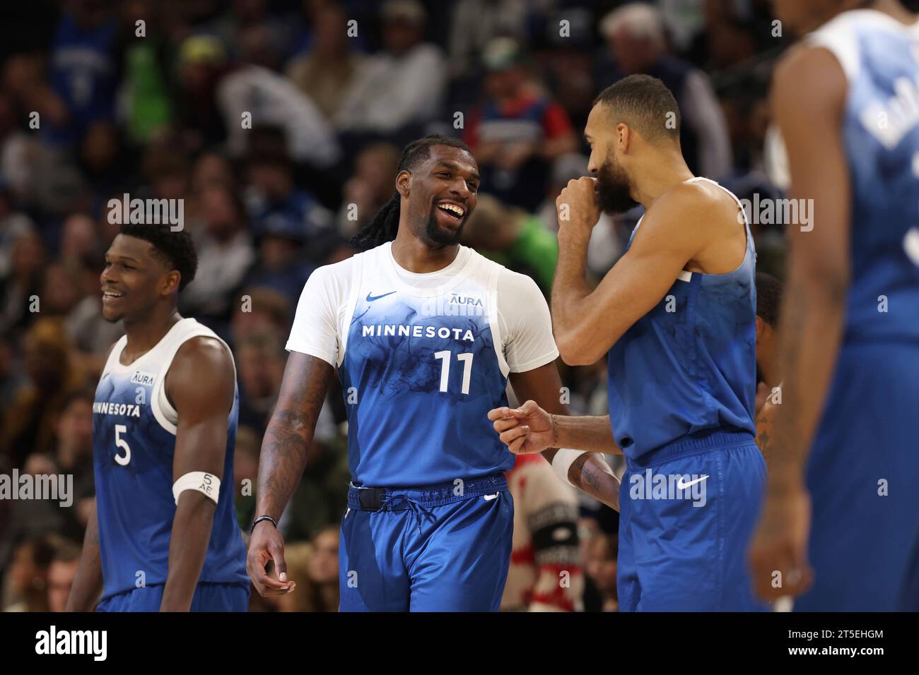Minnesota Timberwolves center Naz Reid (11) laughs with teammate Rudy Gobert, center right ...