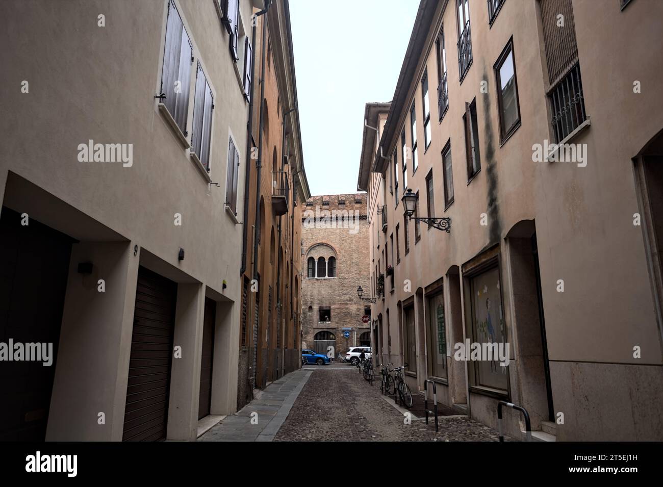 Cobbled and narrow alley between buildings on a cloudy day in an ...