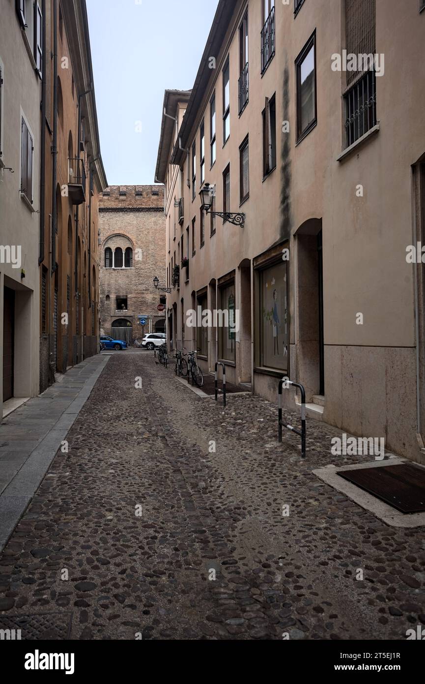 Cobbled and narrow alley between buildings on a cloudy day in an ...