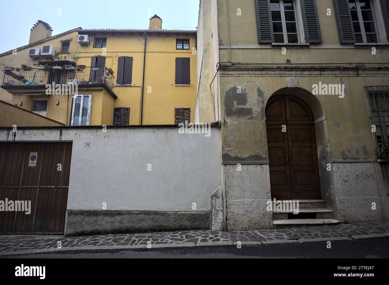 Facade with door and garage in a street of an italian town Stock Photo ...
