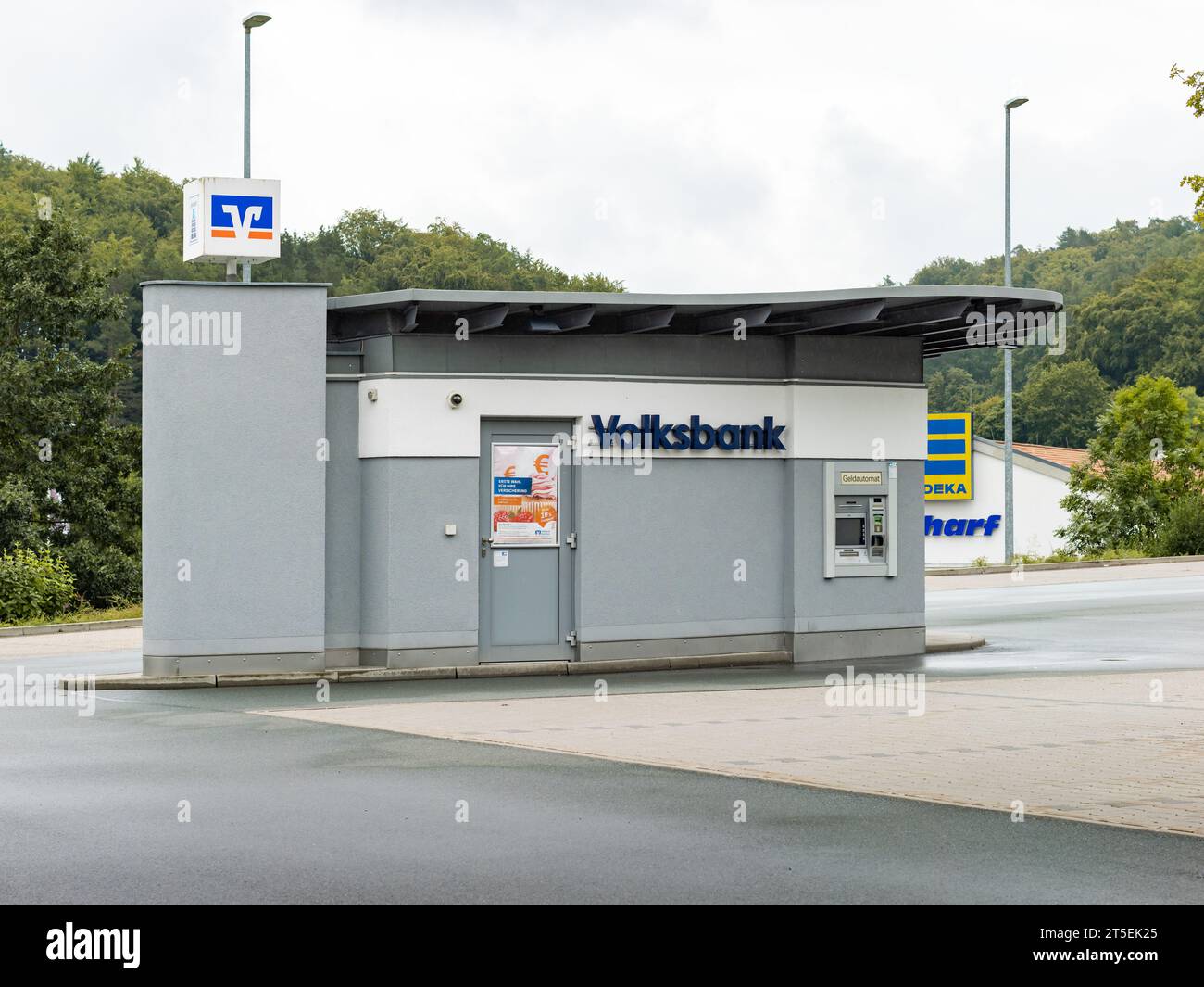 Volksbank ATM in a small building on a parking lot space. Money machine ...