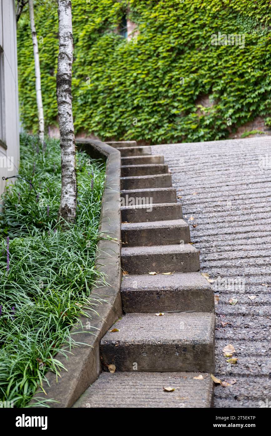 Step walkway next to the road with greenery in the background Stock ...