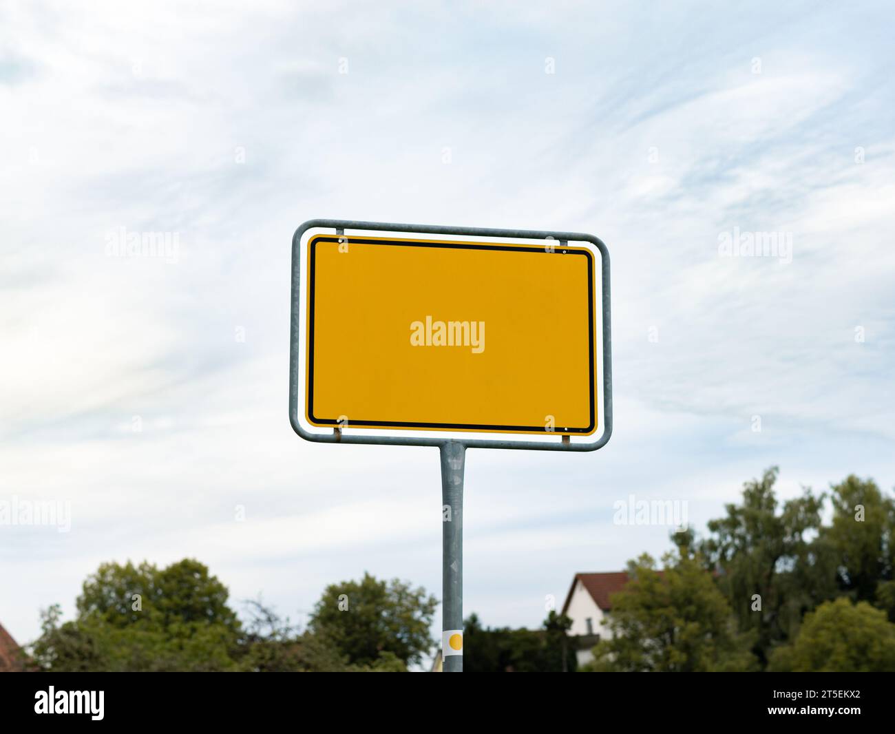 Empty town name sign in Germany. Yellow entry sign in front of a ...