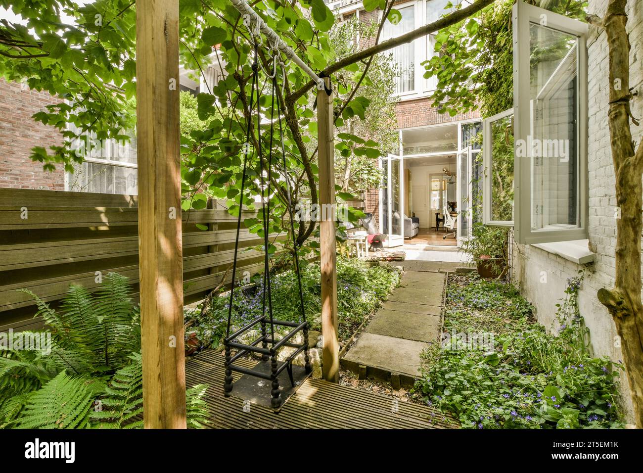 an outside area with trees, plants, and benches in the middle part of ...