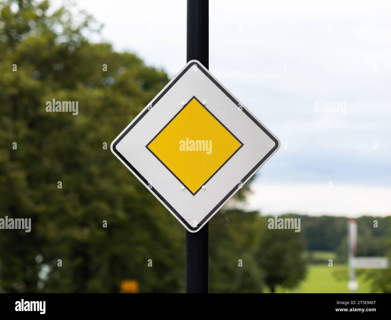 Priority road traffic sign on a pole in Germany. Main street symbol in ...