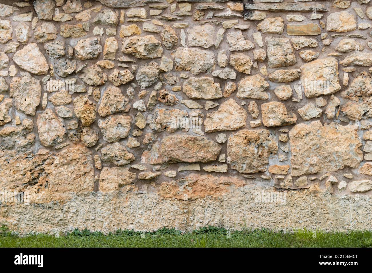 Old stone wall background texture. The building exterior is made of ...