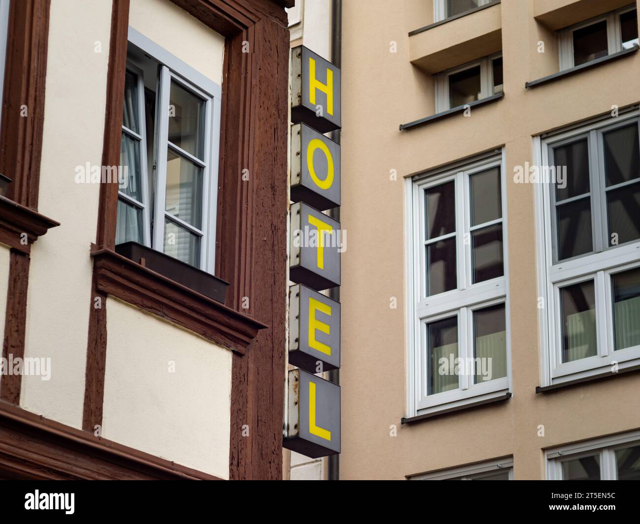 Hotel sign with vertical letters on a building exterior. The ...