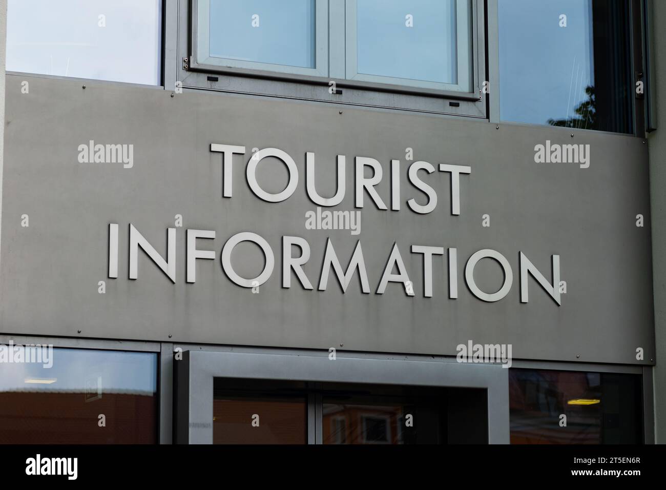 Tourist information in big letters on a building facade. Close up of ...