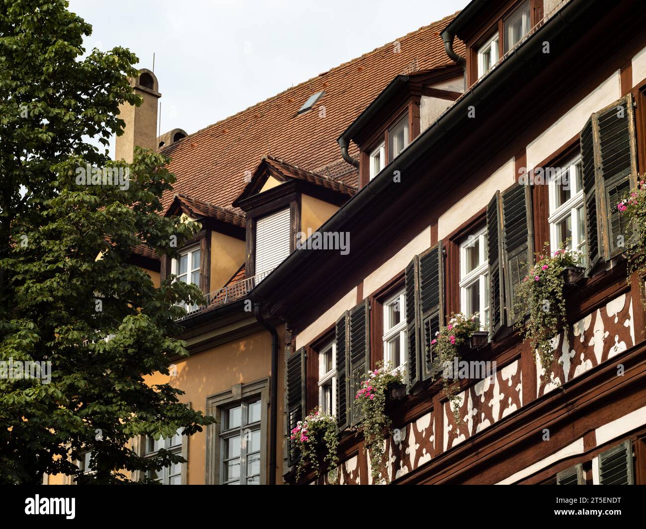 Half timbered building facade with beautiful flower pots on the ancient ...