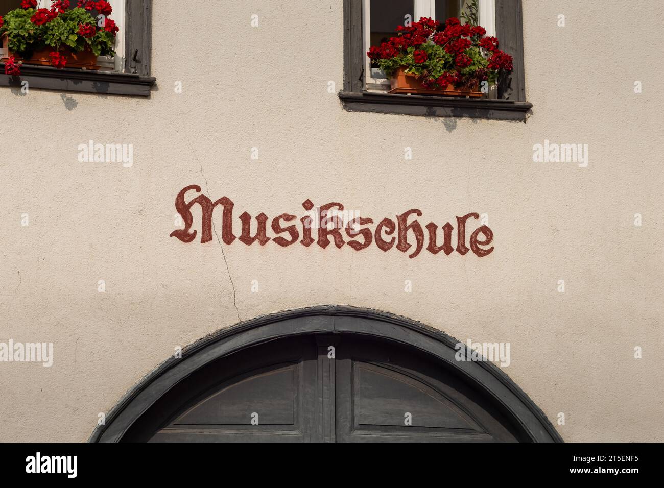 Musikschule (music school) in old writing on a building facade. Sign in ...