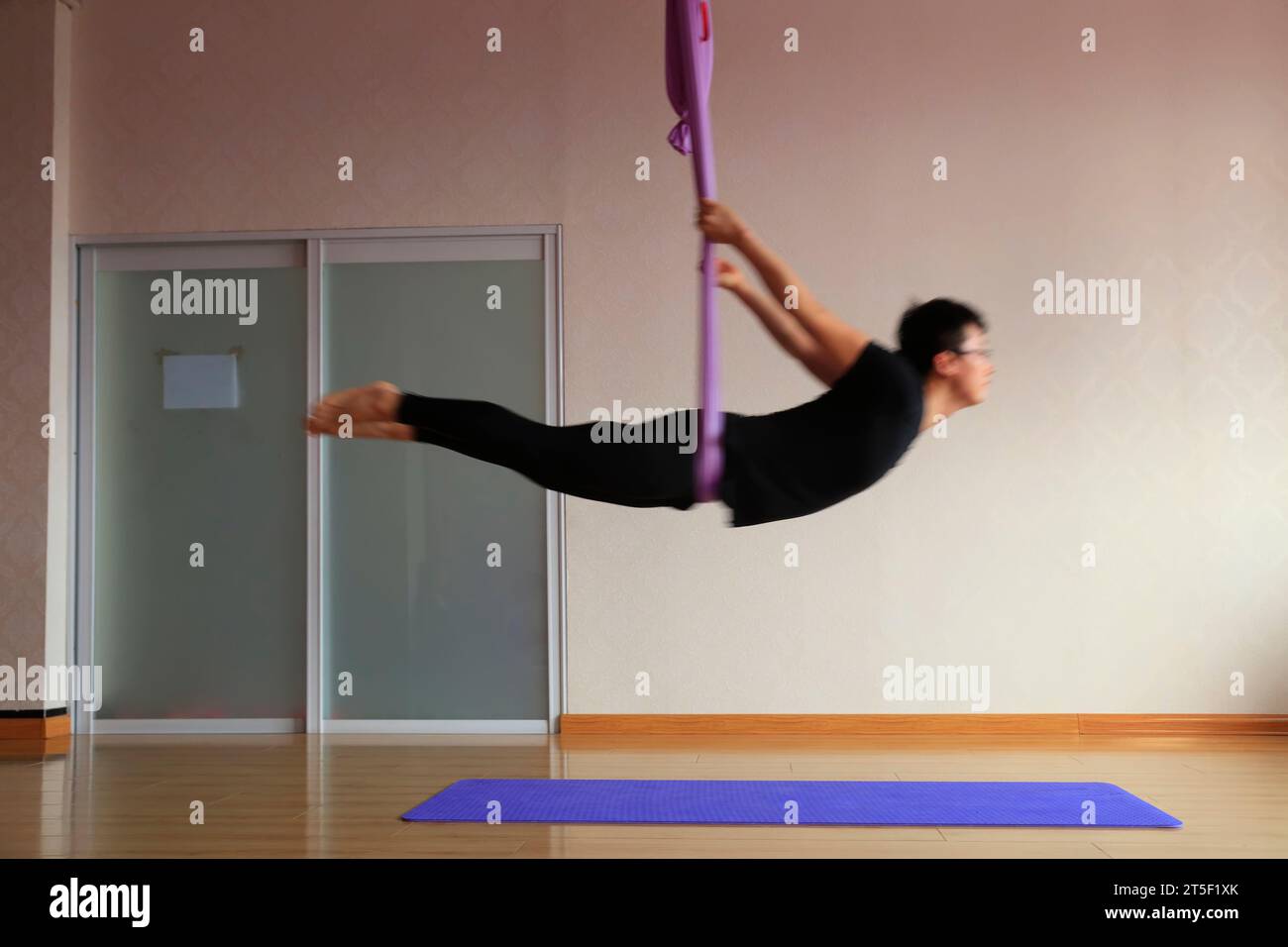 Fuzzy images of air yoga exercise Stock Photo - Alamy