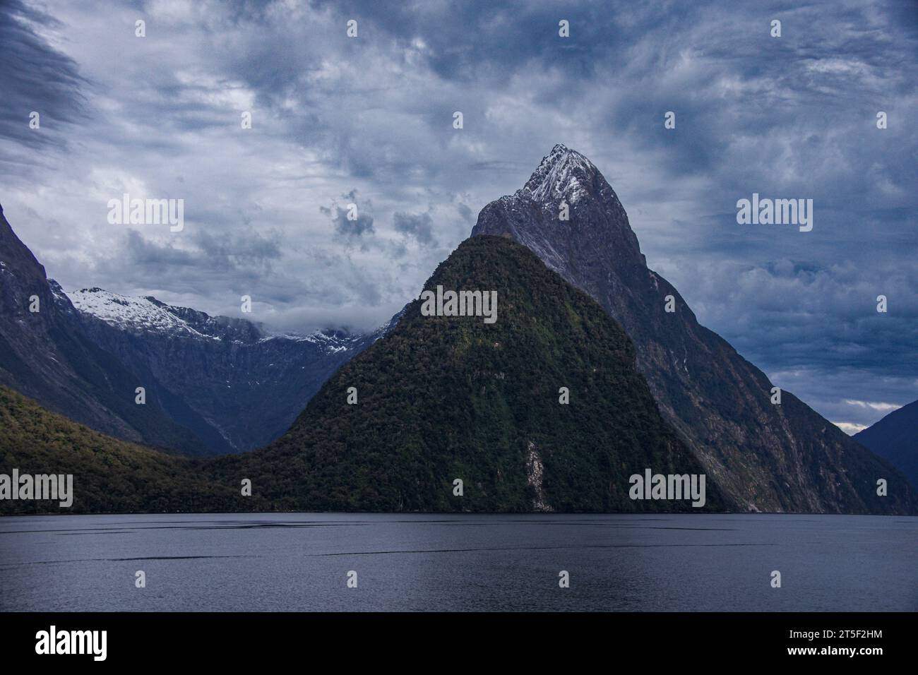 Mitre Peak surrounded by dark clouds in Milford Sound New Zealand Stock ...