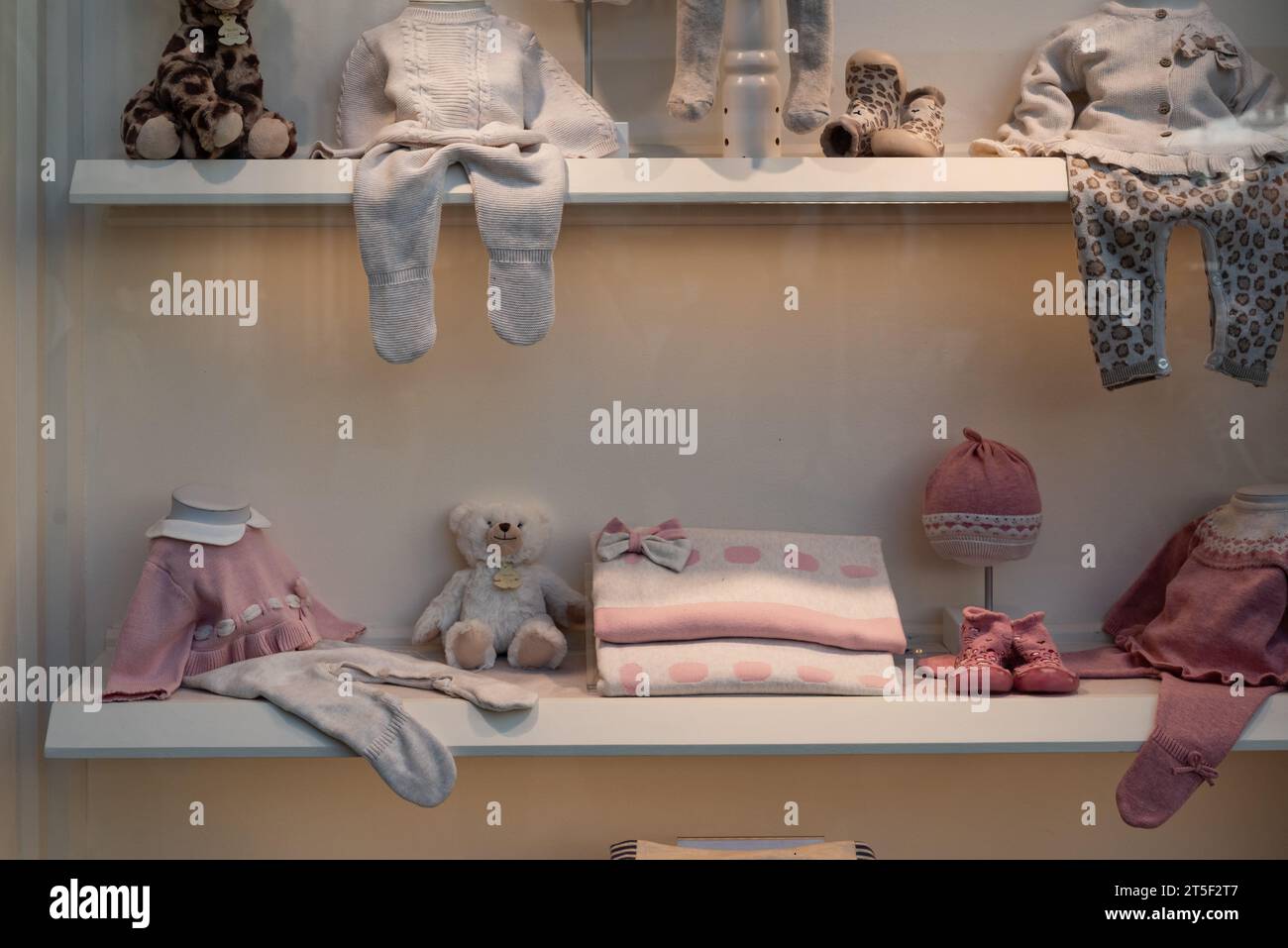 baby clothes, shoes and toys on display in a store window Stock Photo ...