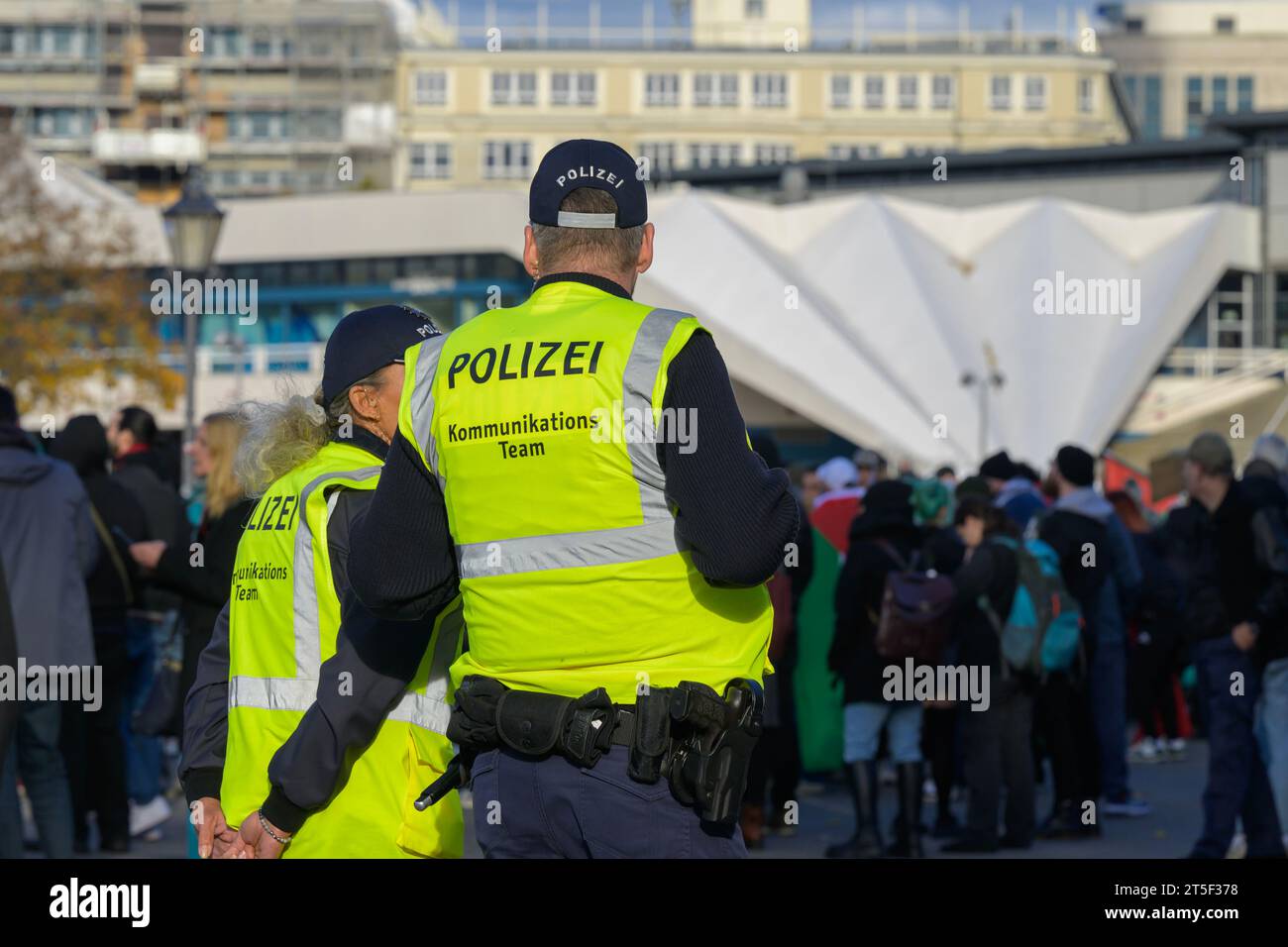 Two police officers wearing safety vests with the German inscription ...