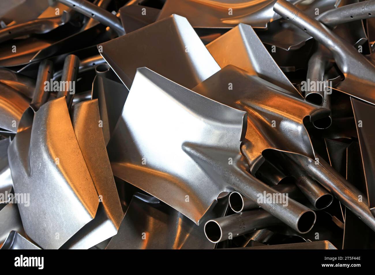 Piles of steel spades Stock Photo - Alamy