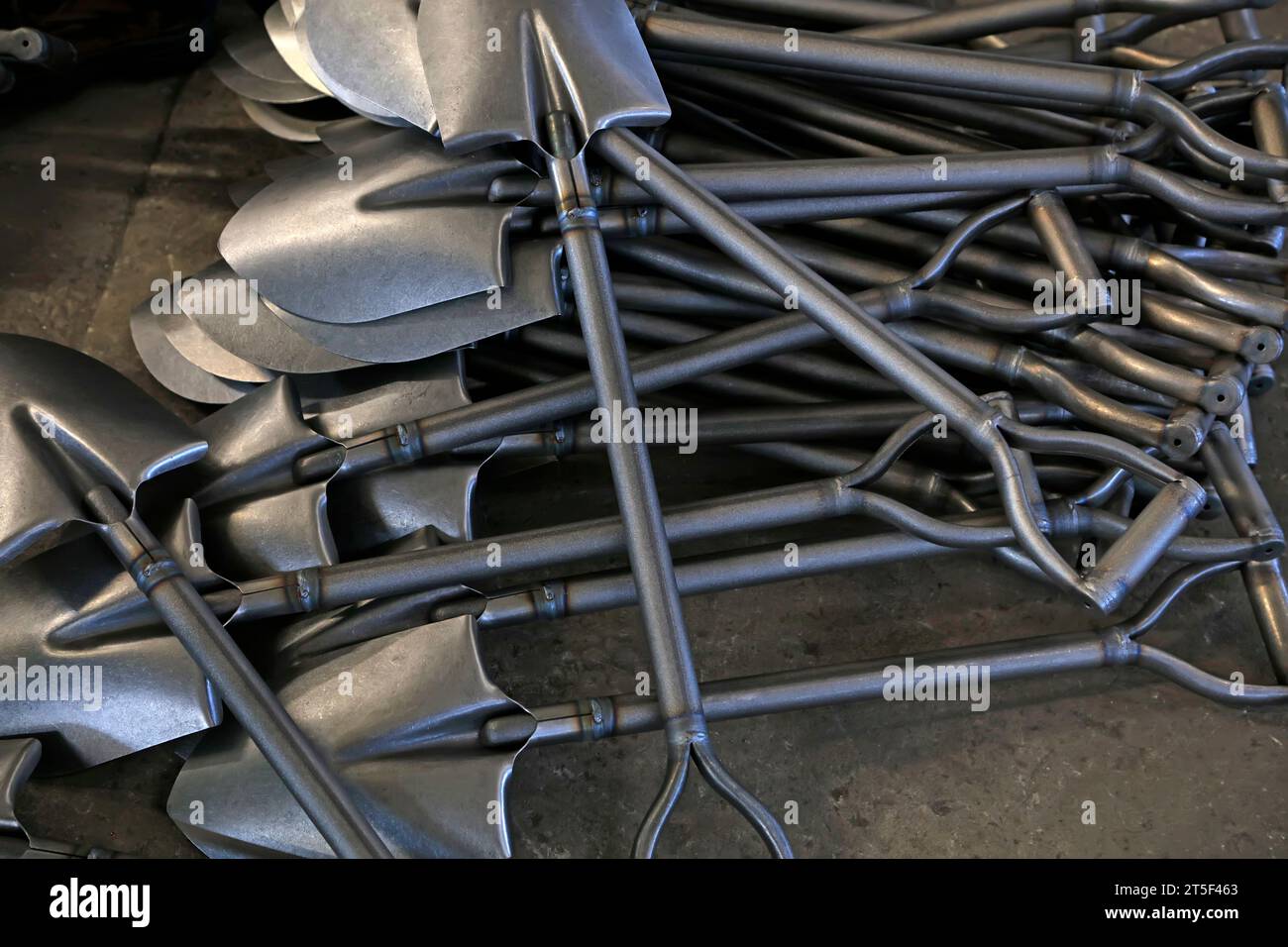 Piles of steel spades Stock Photo - Alamy