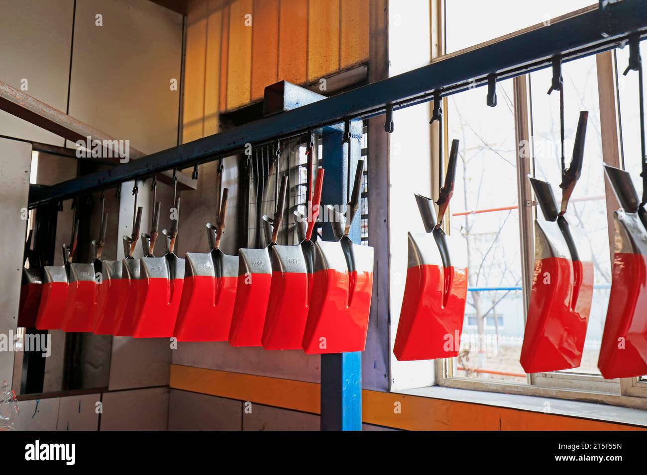 Steel spade spray paint production line Stock Photo - Alamy