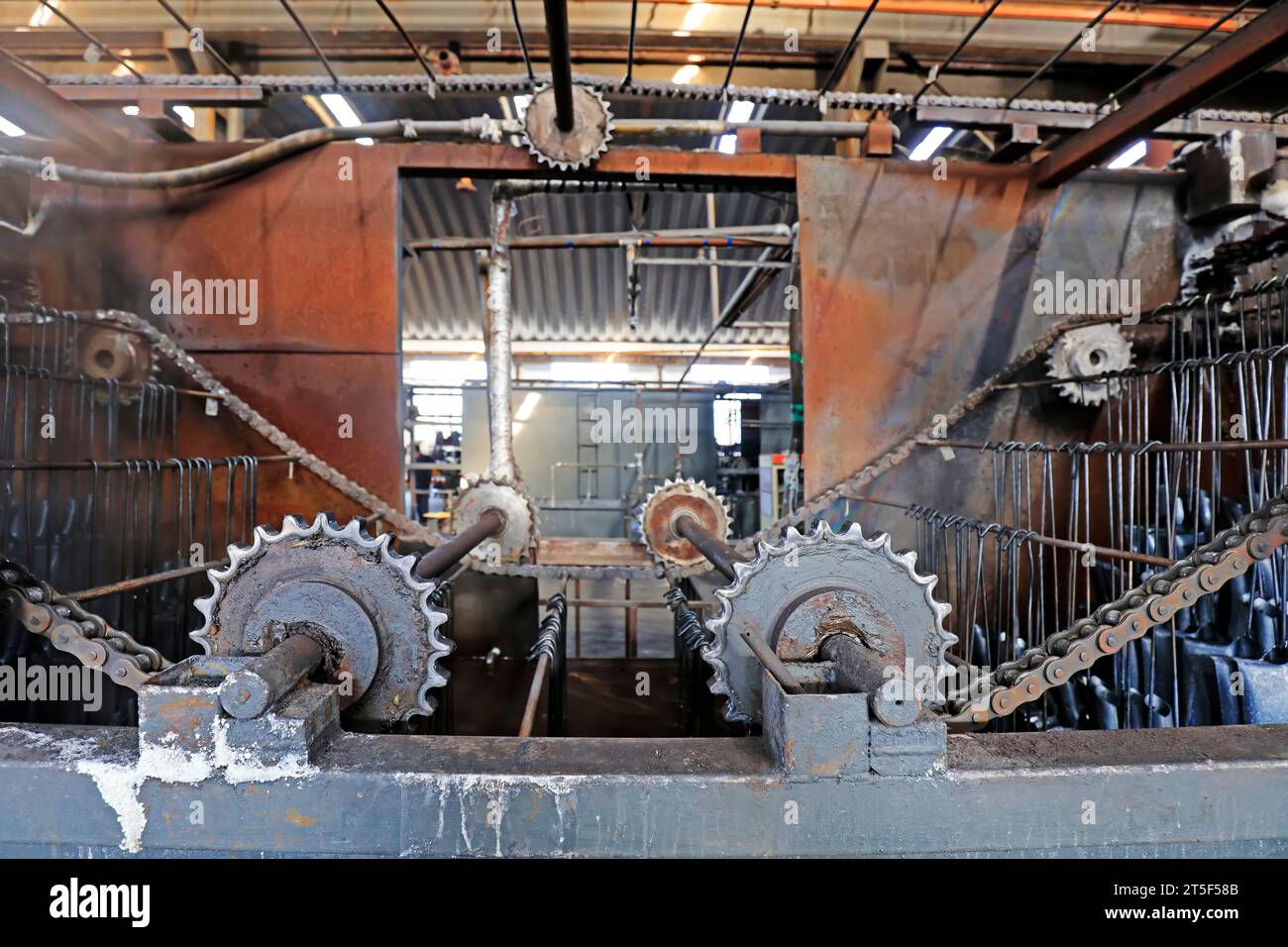 Transmission gear of steel spade production line Stock Photo - Alamy