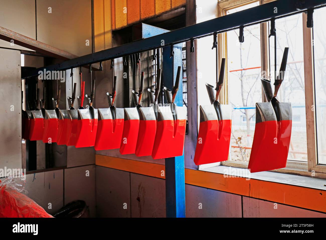 Steel spade spray paint production line Stock Photo - Alamy