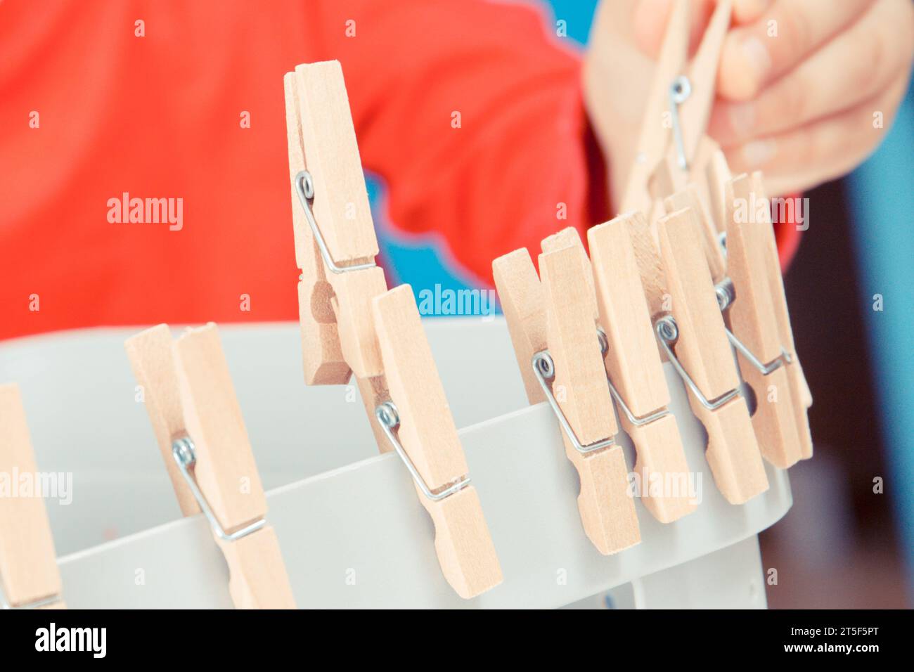 Little boy putting wooden clip on plastic box. Best creative game for ...