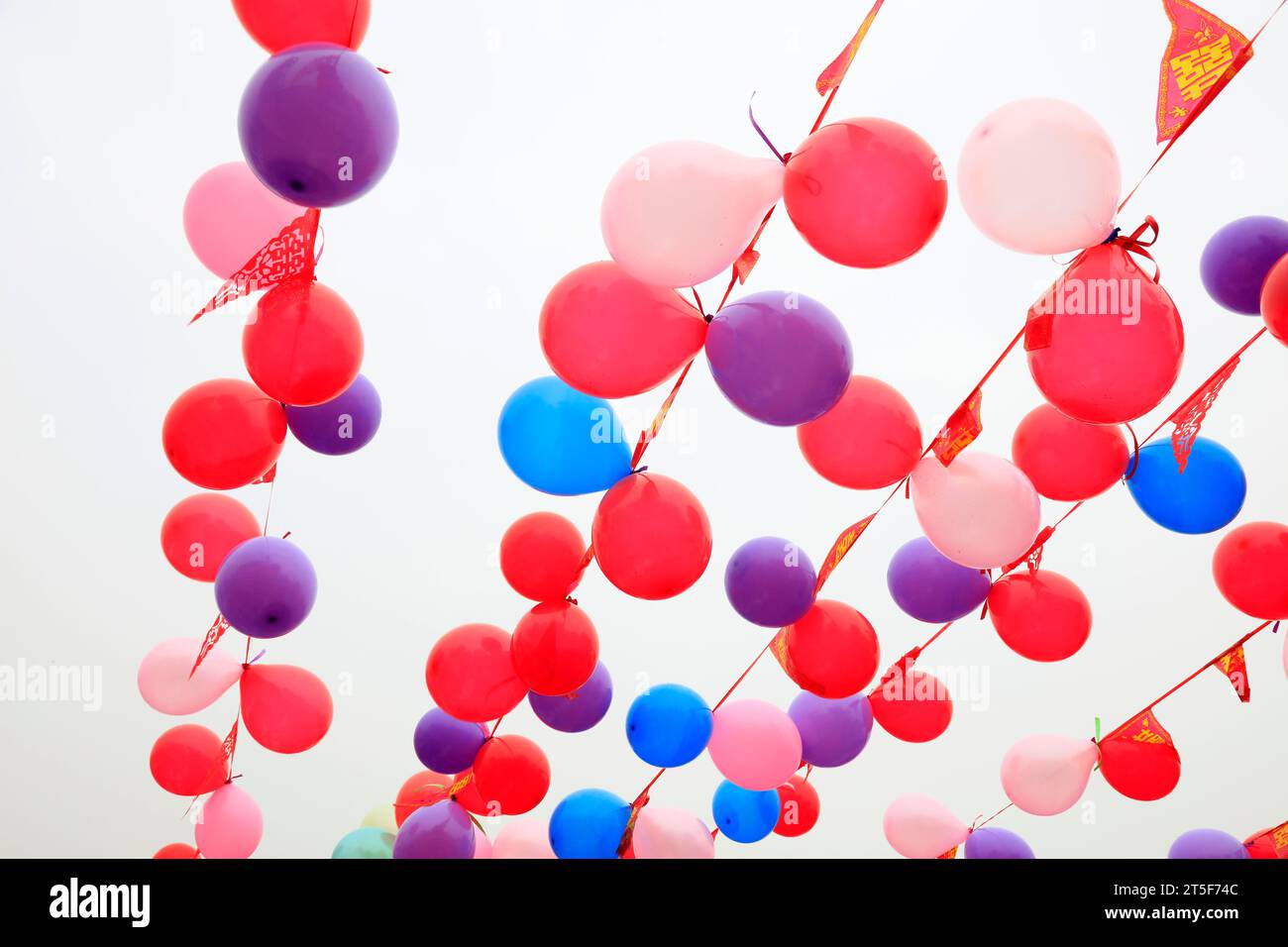 Festive balloons and coloured flags Stock Photo - Alamy