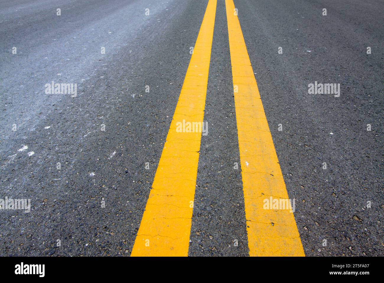 yellow double solid line on the road Stock Photo - Alamy