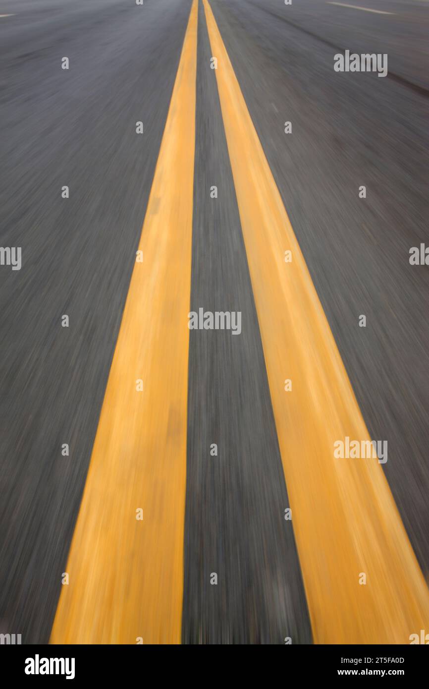 yellow double solid line on the road Stock Photo - Alamy
