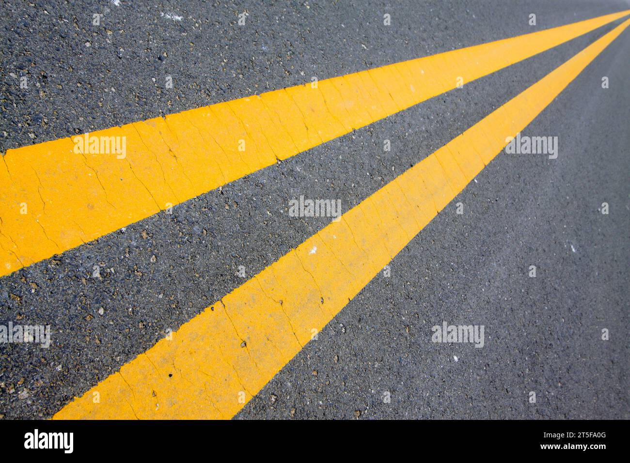 yellow double solid line on the road Stock Photo - Alamy